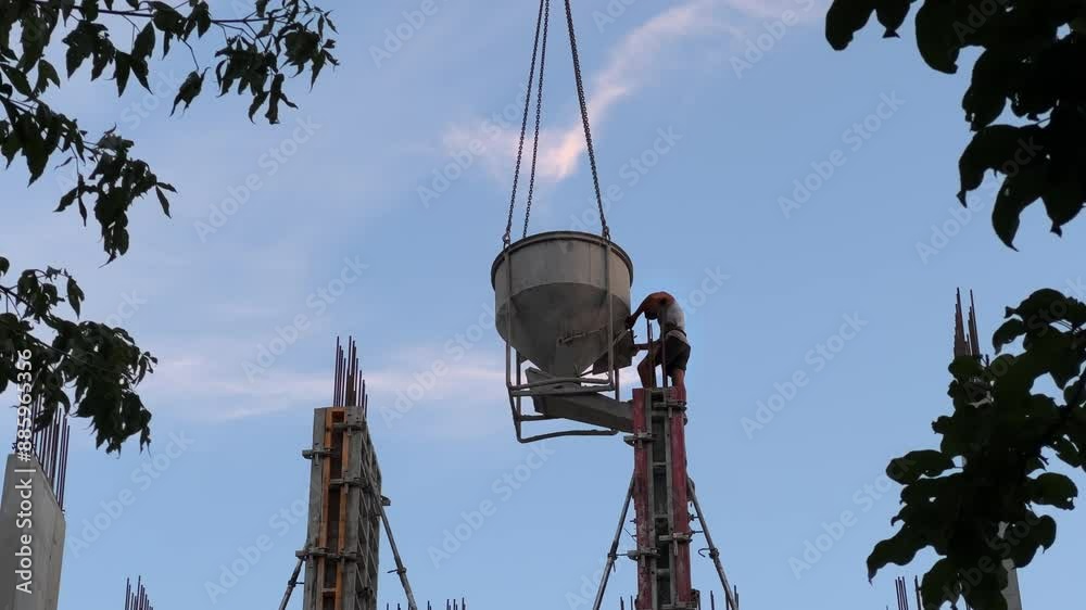 High-Rise Construction: Worker Silhouette Operating Concrete Bucket ...