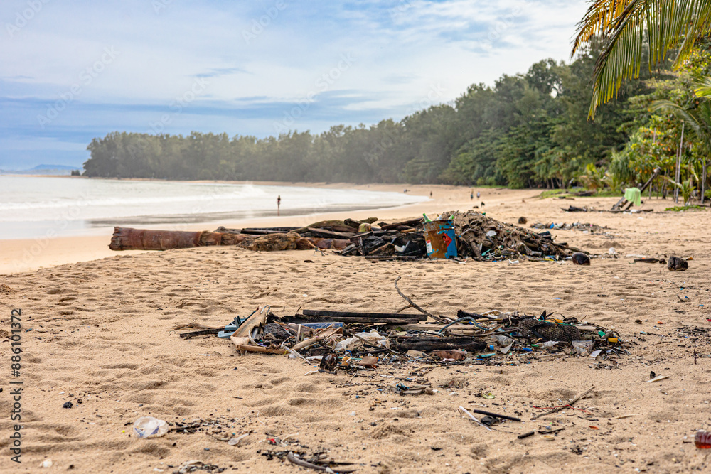 Marine debris. Spilled garbage on the sandy beach after a sea storm in ...