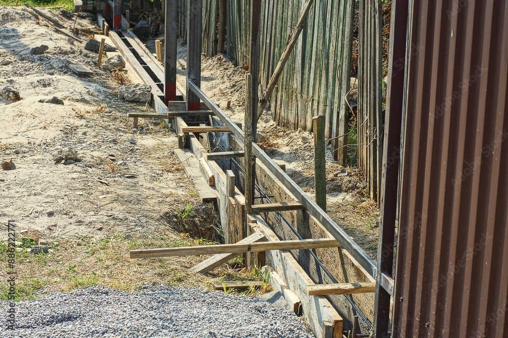 homemade wooden formwork with boards in the ground in a deep trench ...