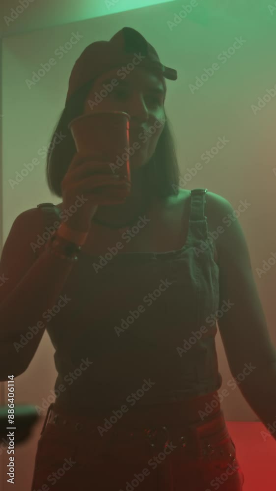 Vertical side shot of fashionable ladies in y2k outfits dancing in ...