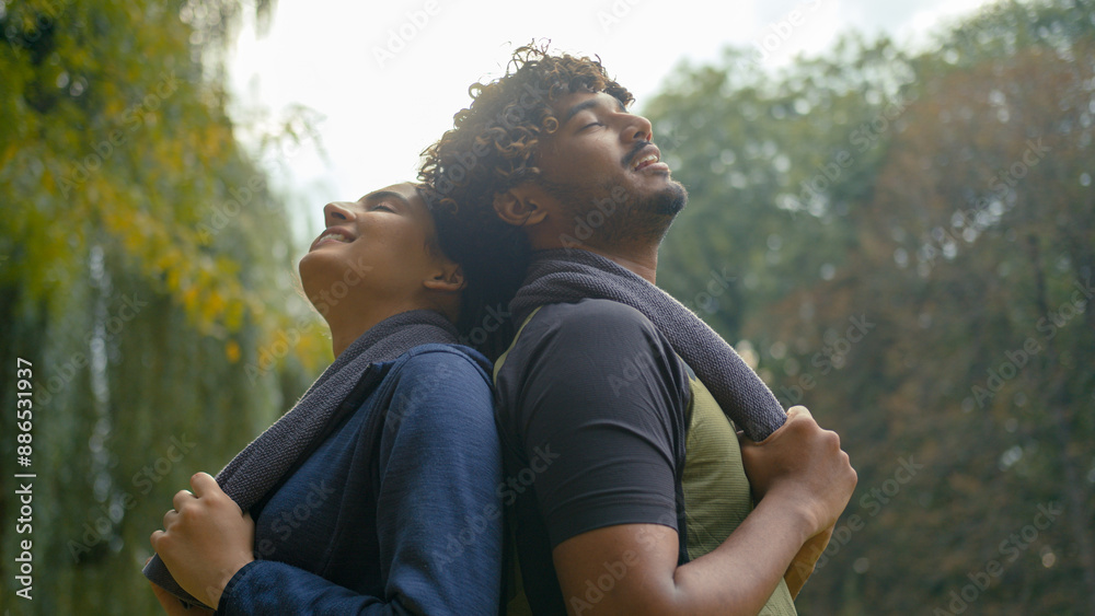 Two tired exhausted sweaty sport people rest relaxing leaning back to ...
