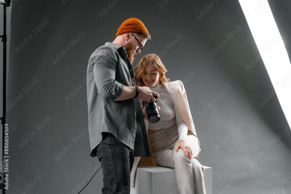 Photographer and model review shots for composition and expression ...