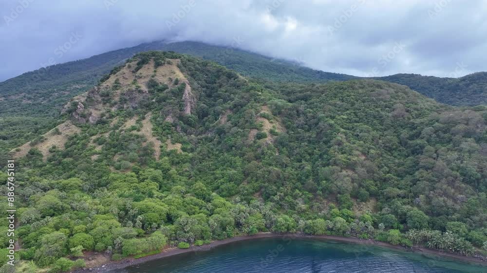 Clouds gather around the peak of the scenic volcano of Lewotolok on ...