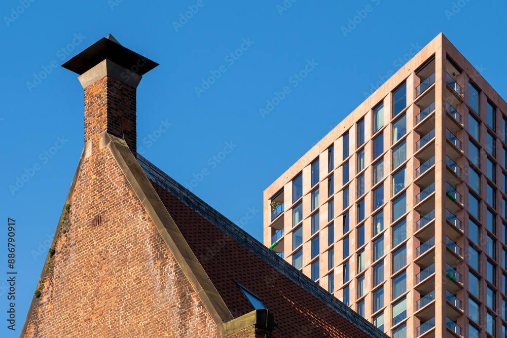 An architectural photograph featuring a historic brick chimney set ...
