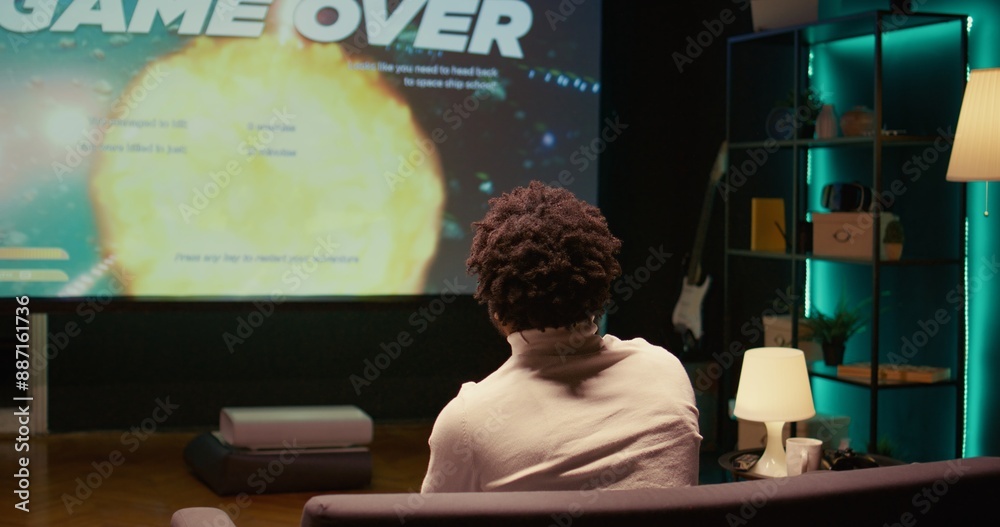 Upset african american gamer raging after losing game, playing on ...