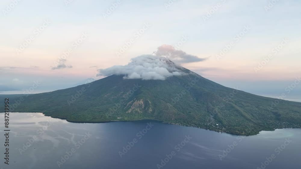 A serene dawn illuminates the scenic volcano of Lewotolok on island of ...