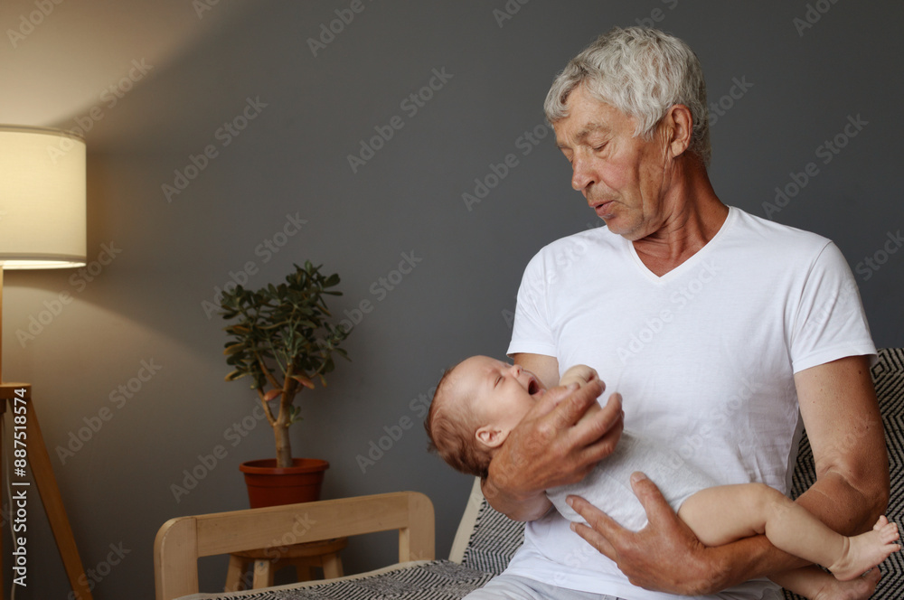 Grandfather and grandchild bonding. Retired man with newborn grandson ...
