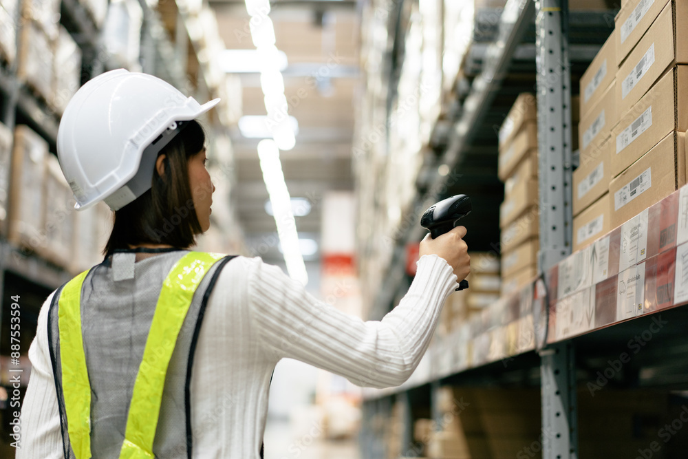 Warehouse Supervisor in safety suite use scanner to check and scan ...