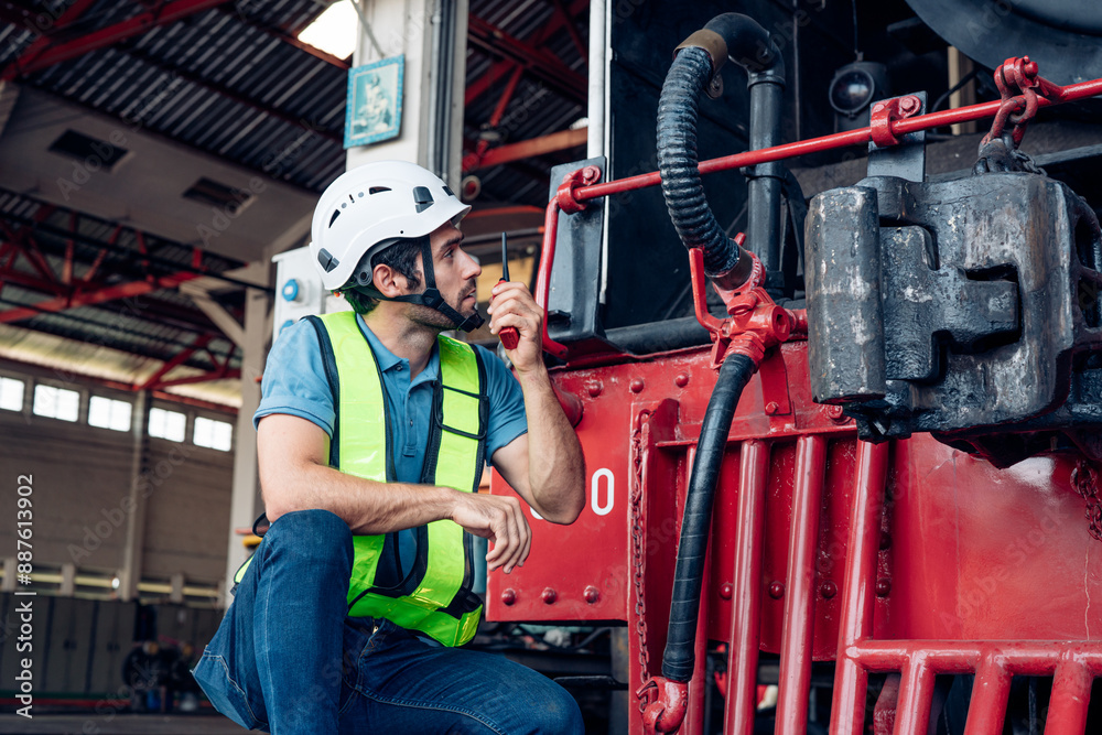 Engineer railway wearing safety uniform and helmet under checking under ...