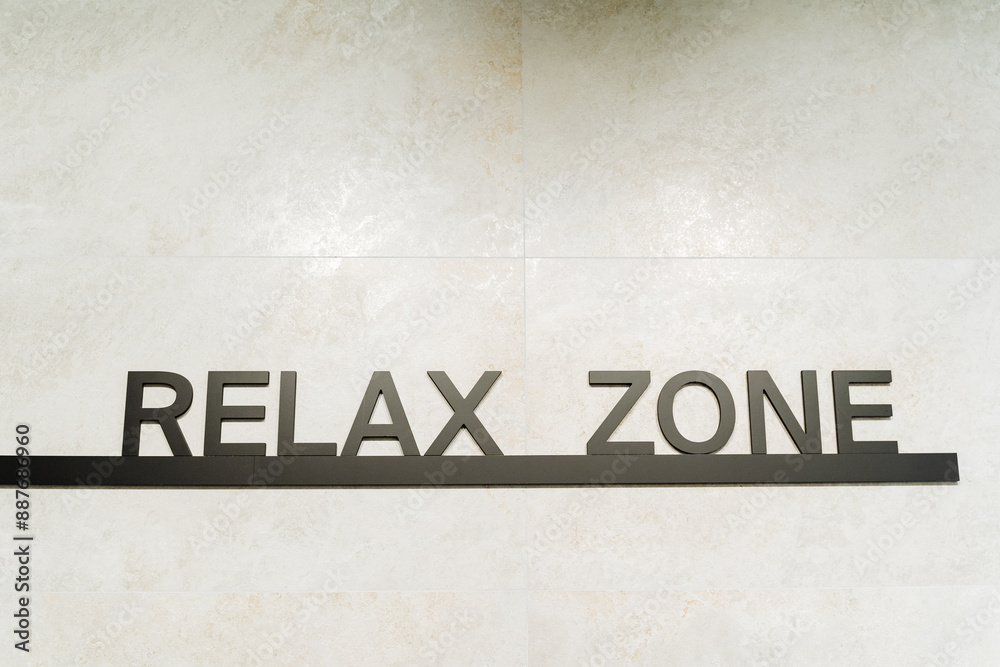 Rectangular relax zone sign with artistic font and graphics on a wall ...