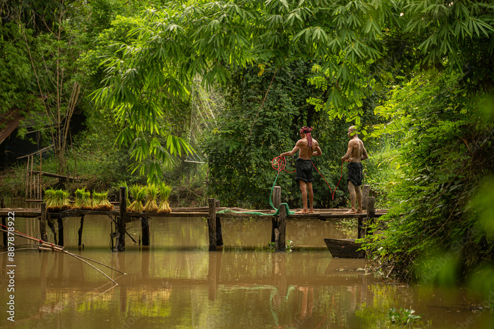 The farmer helps and talks to the fisherman who is using a fishnet to ...