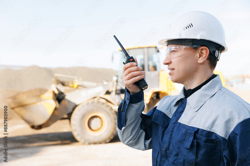 Industrial worker of sand quarry use radio walkie talkie background ...