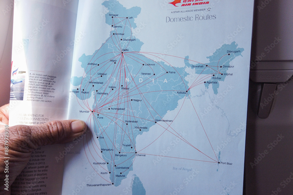 An India Map in hand with detailed Domestic routes marked in red color ...