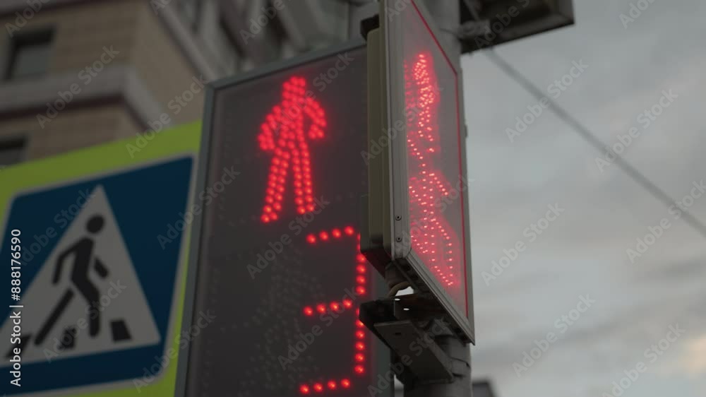 Close-up view of a digital pedestrian traffic light displaying a red ...
