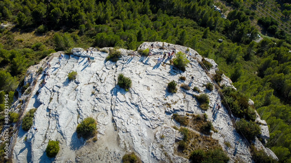 Aerial view of a French village perched in the mountains. Rock spur on ...