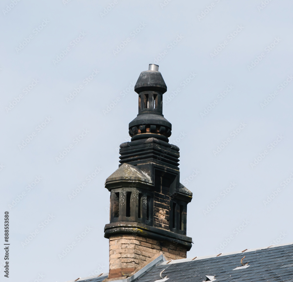 A detailed stone chimney stands proudly on a rooftop in Haguenau ...