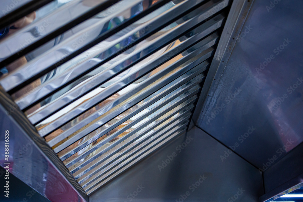 Stainless steel exhaust hood with grease trap close-up in a large ...