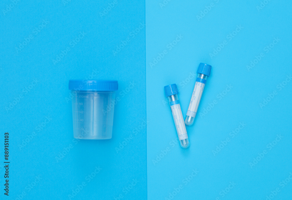 Medical blood test tubes and urine test jar on a blue background Stock ...
