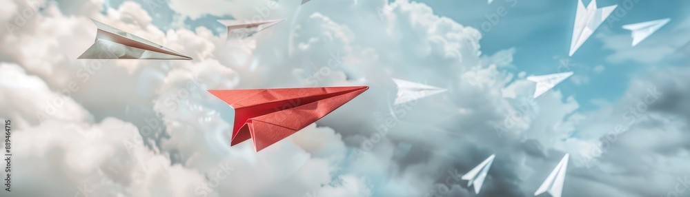 A red paper airplane is flying through a cloudy sky with many other ...