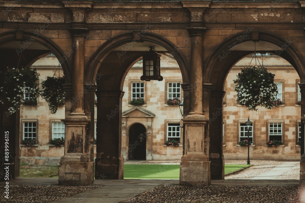 Stone archways leading into a courtyard in Cambridge, UK. Hanging ...