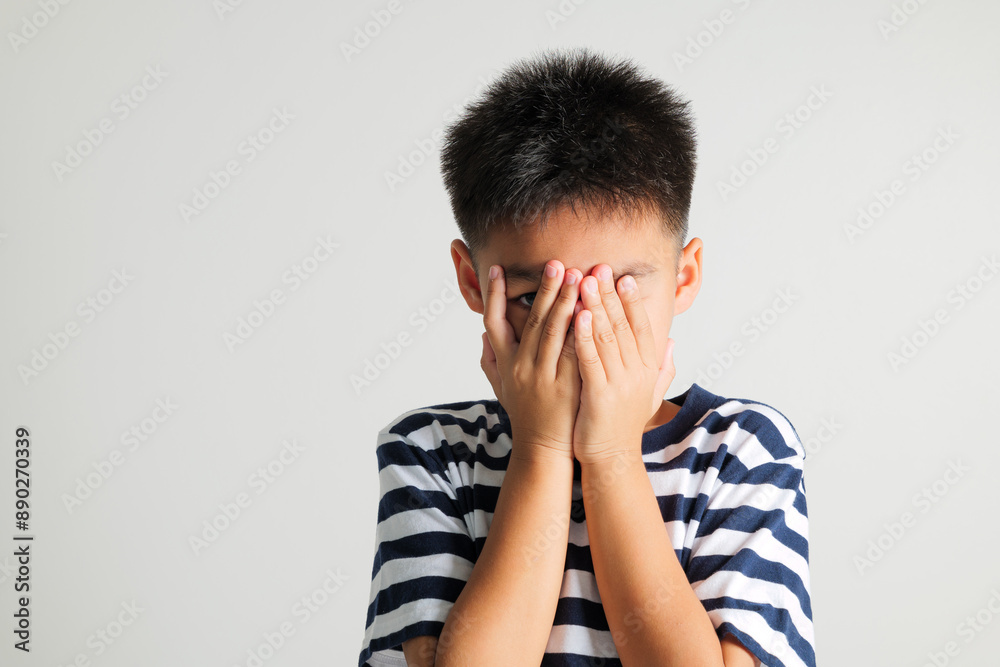 Asian portrait young kid boy in depressed bad mood covering face with ...