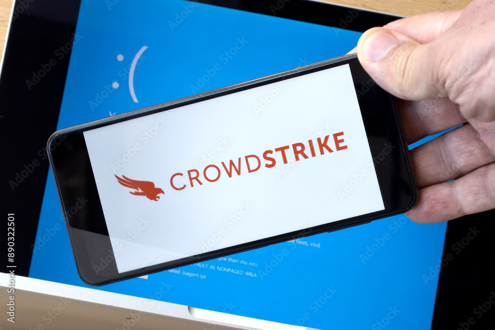 CrowdStrike logo and blue computer screen during mass tech outages ...
