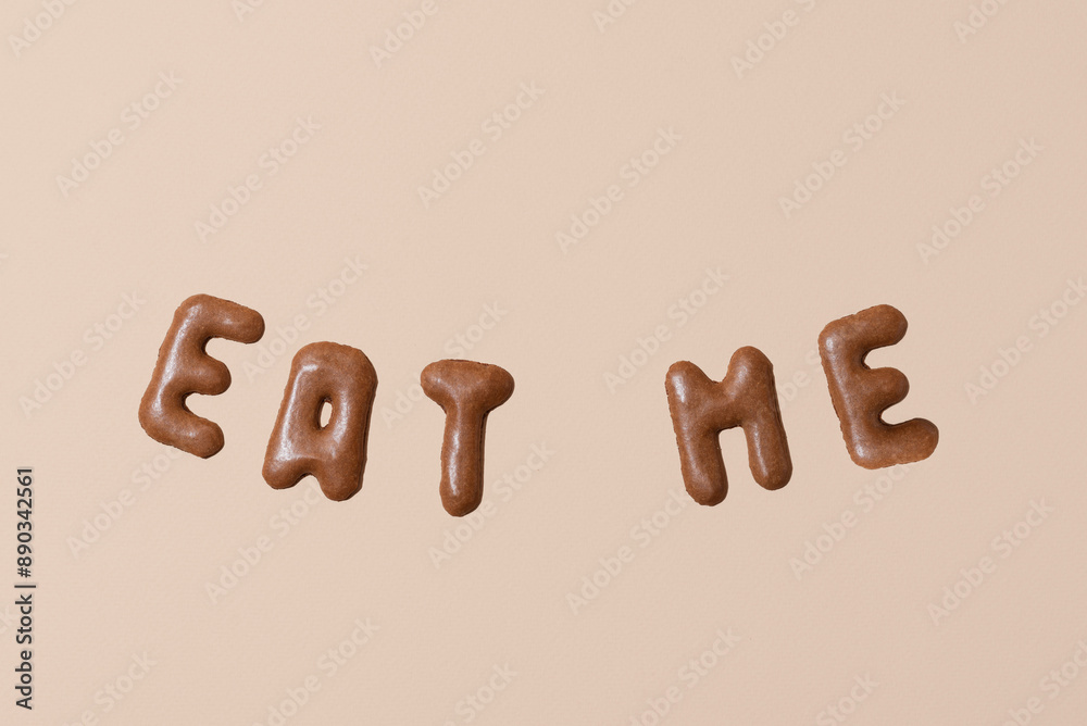 Sweet composition with the words Eat Me on a beige background. Alphabet ...