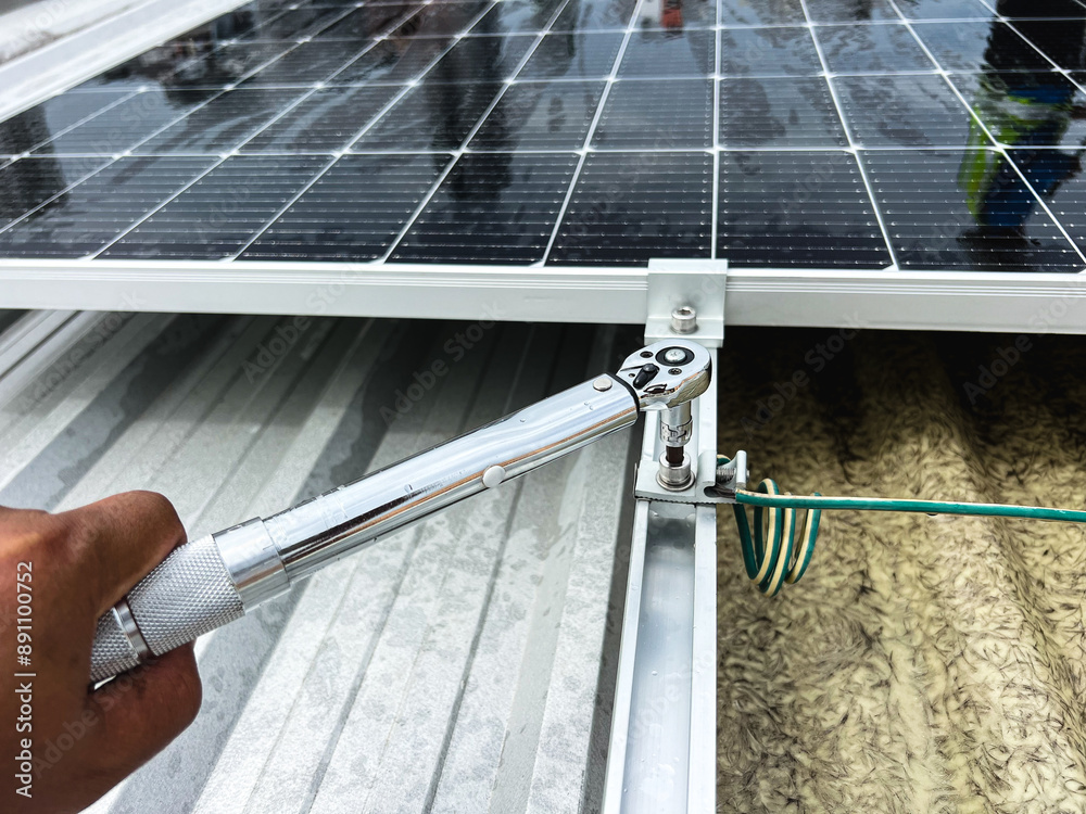 Testing the torque of the solar panel mounting rail nuts. Stock Photo ...