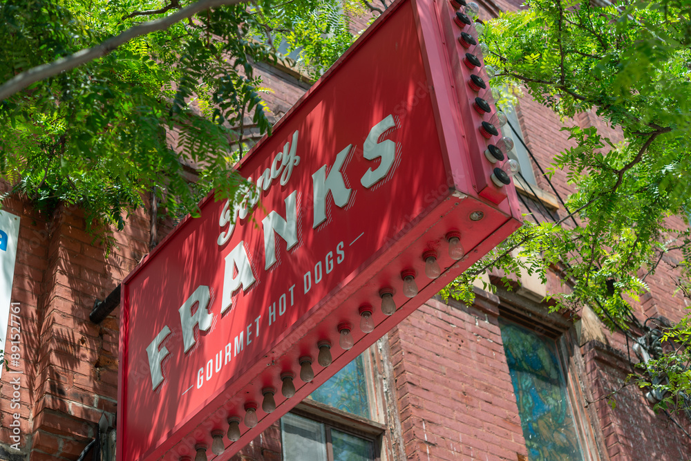 vintage projecting sign with marquee lamps over entrance to Fancy ...