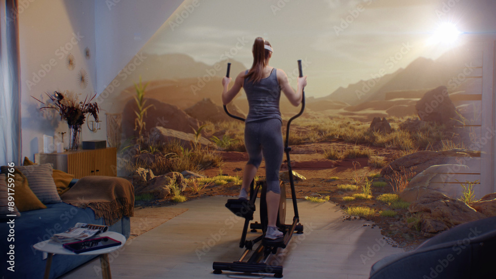 Sportswoman wearing VR headset trains on orbitrek simulator. Virtual ...