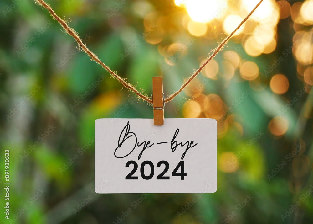 Note paper with text Bye-bye 2024 hanging on a rope, concept of saying ...