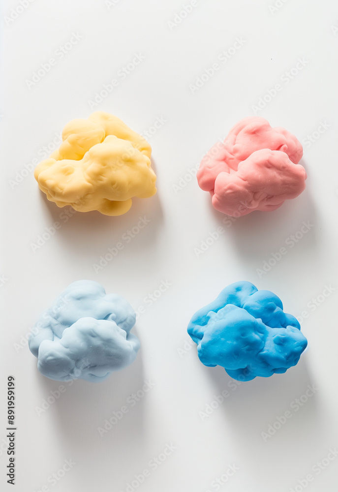 Four different colors of soft, fluffy playdough shaped like clouds are ...