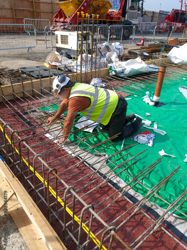 Radon gas membrane inspection at a construction site with workers in ...