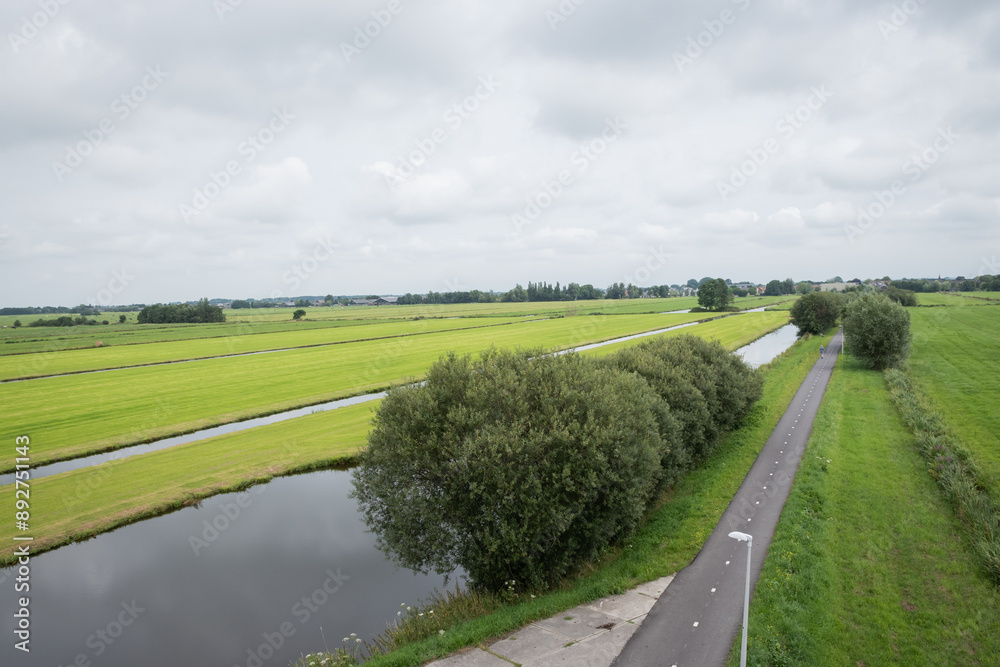 Dutch rural countryside scene in the flat polder farmland. straight ...