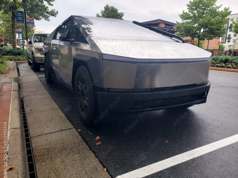 Tesla electric Cybertruck in a store parking lot with raindrops on the ...
