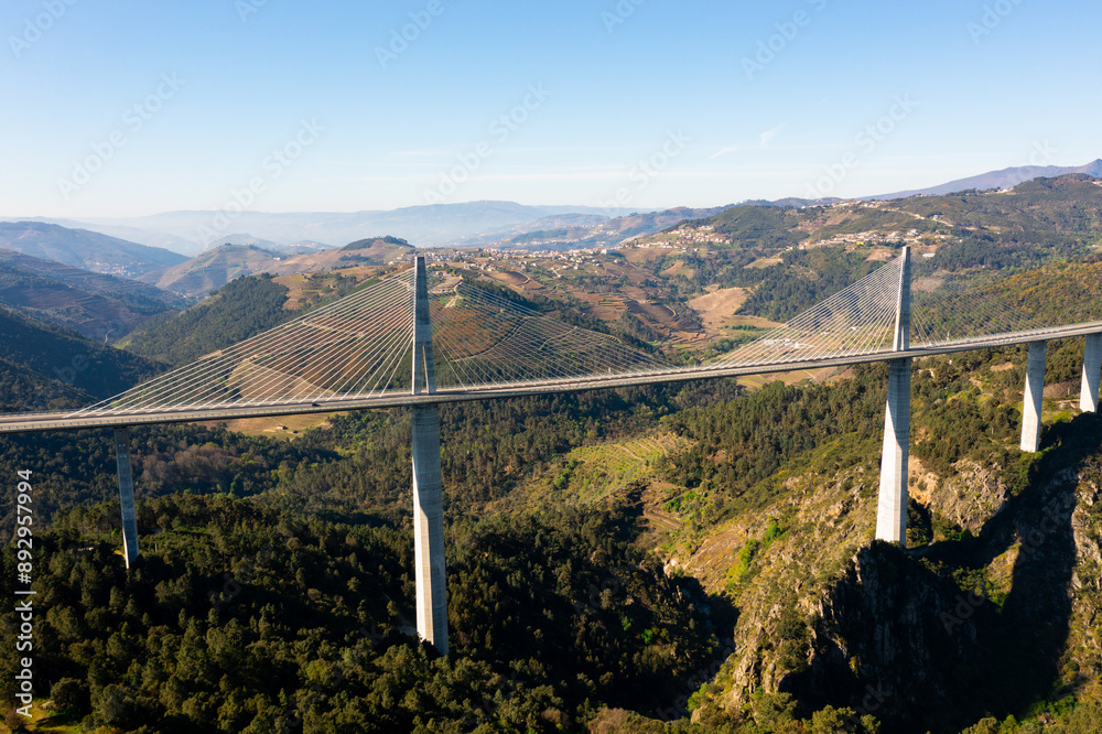 Scenic aerial view of vehicular suspension bridge supported by concrete ...