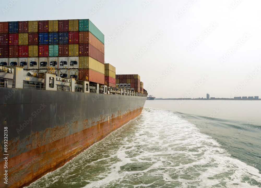 Container ship with cargo on river at Western Scheldt in Netherlands ...