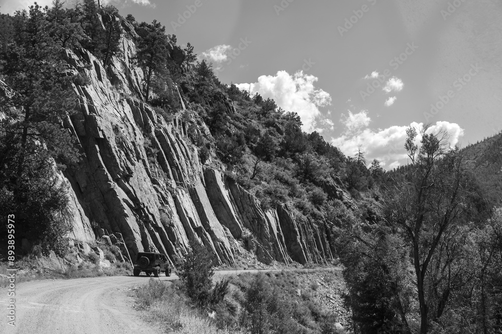 Graveled back road through the Phantom Canyon with steep granite bluffs ...
