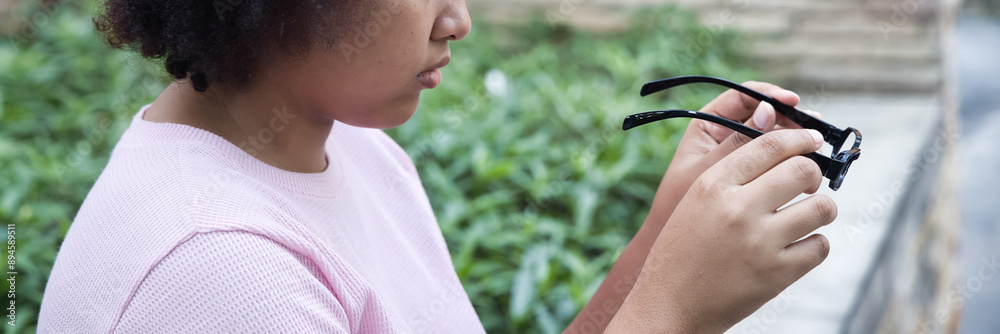 Young African woman with eyesight issue, concept image of premature eye ...
