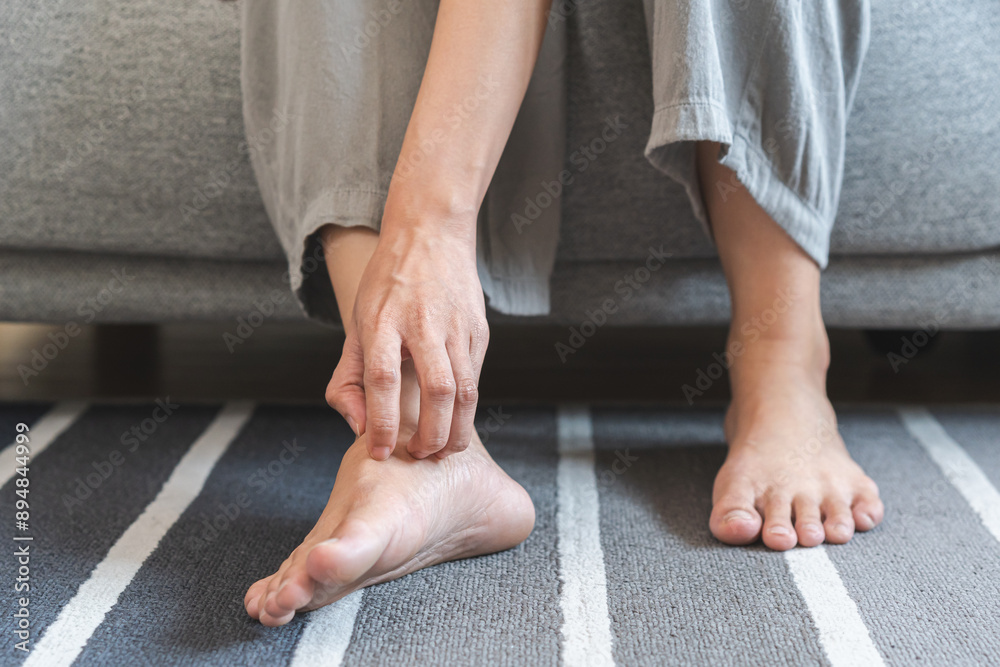 Foot pain, ache asian young woman hand scratch feet, itch foot, problem ...