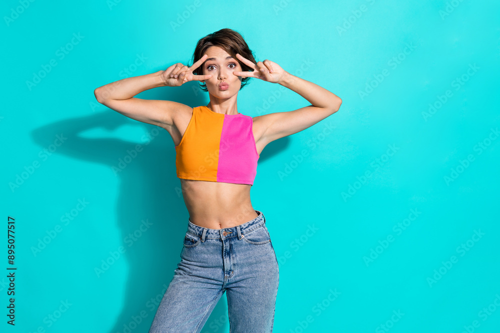 Photo of excited flirty lady dressed colorful top showing two v-signs ...
