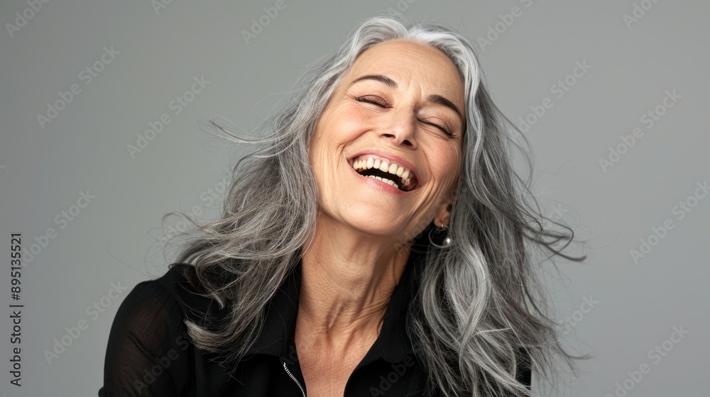 Radiant Senior Woman with Silver Hair - A joyful senior woman with long ...