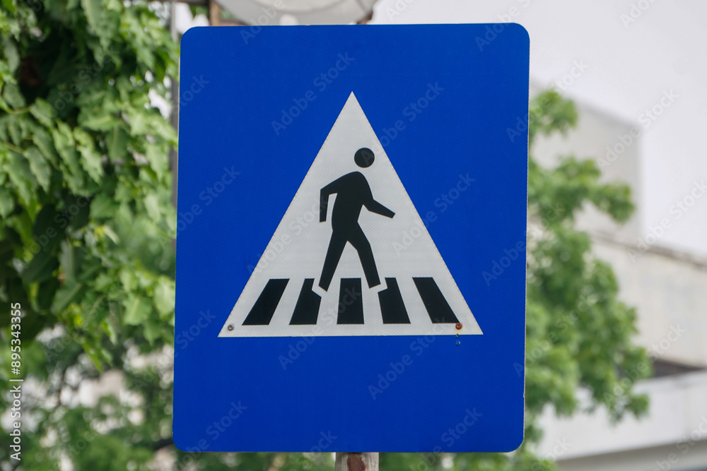 pedestrian crossing sign on the street. traffic symbol in a Jakarta ...