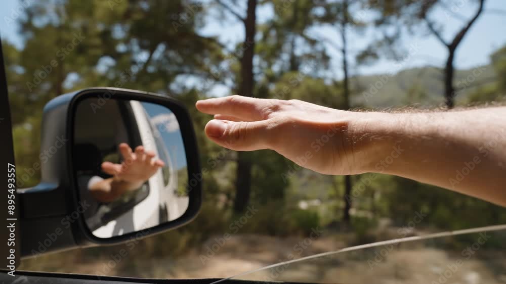 A Hand Reaching Out the Window of a Car, Feeling the Breeze. The Side ...
