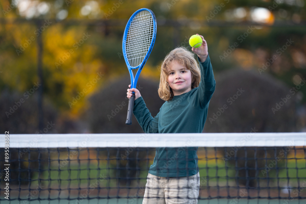 Preteen child swinging racket while training on tennis court at sport ...