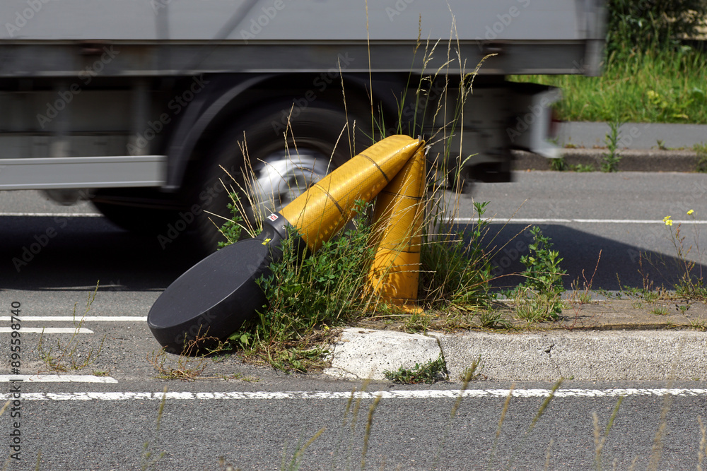 Asphalt street with traffic island with a broken pole with traffic sign ...