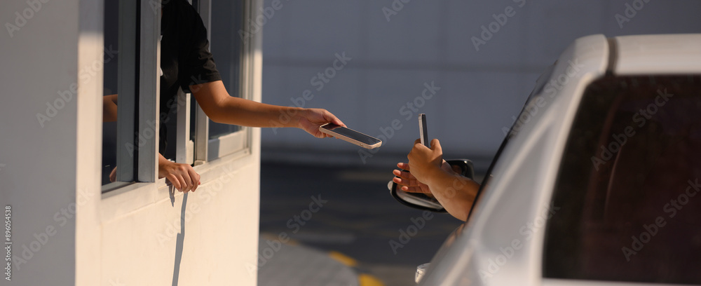 Men scan and pay for food, pick up food from a drive-thru counter and ...