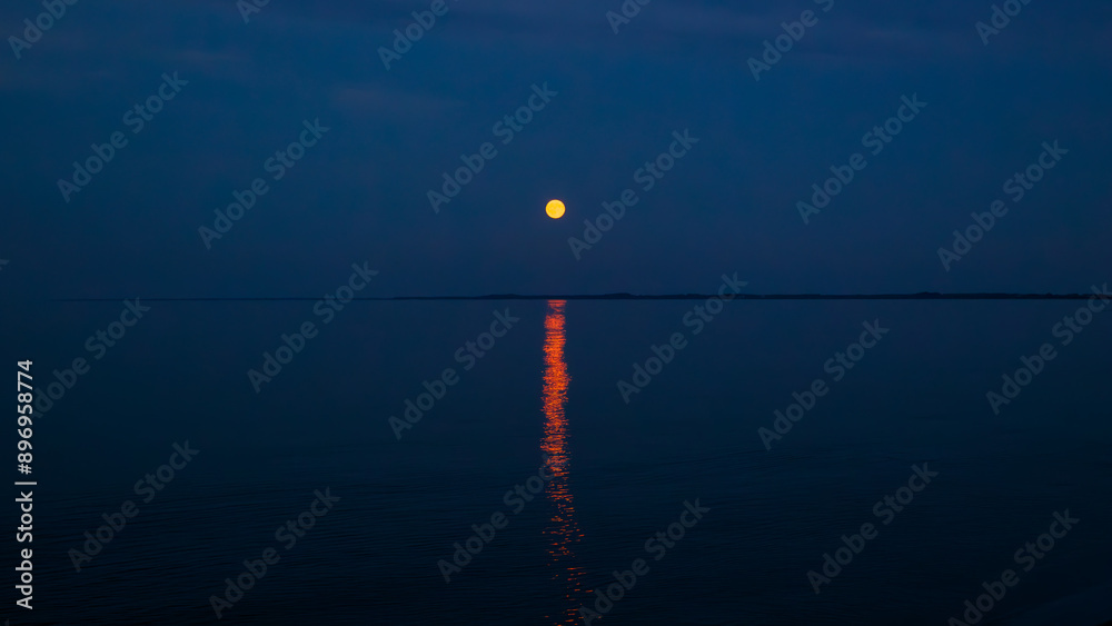 Full moon over the sea at night. View of the Ukrainian Black Sea. A ...