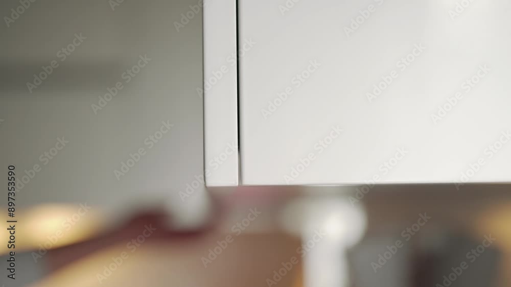 Close-up view of opening a modern kitchen cabinet. Slow opening of a ...