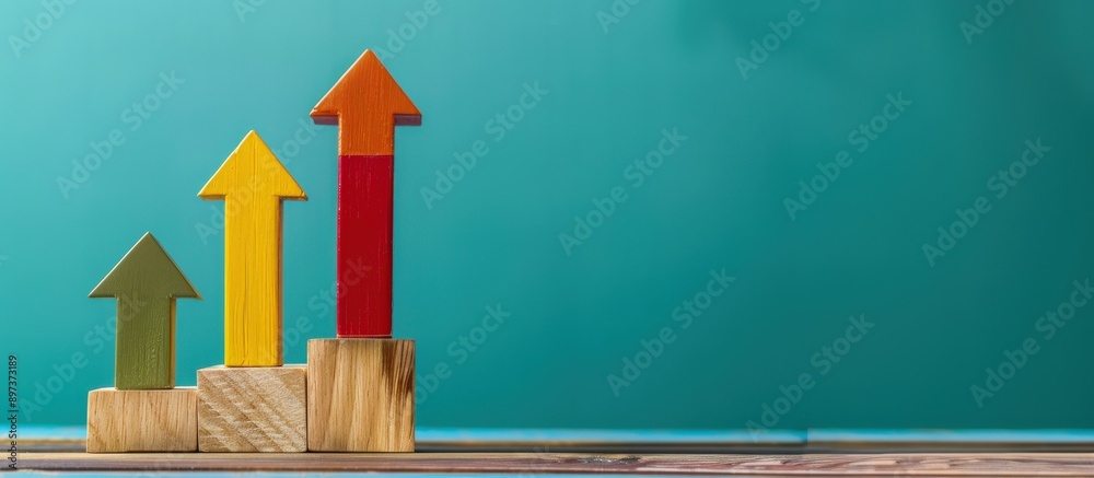 Three wooden blocks with three different colored arrows on top of them ...